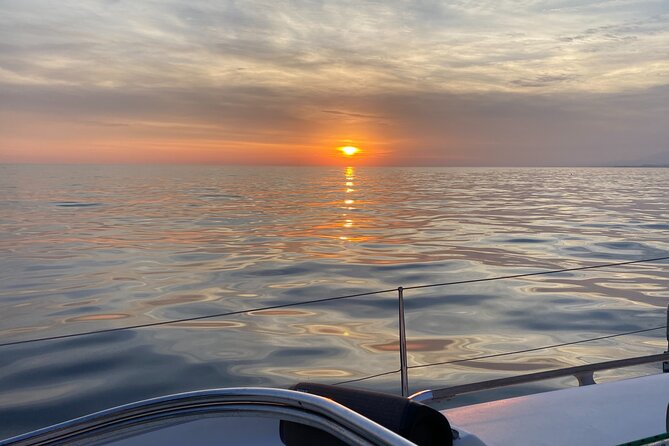 Sailing at sunset along the cliffs of Maro-Compartida - The Sum Up