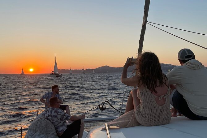 Santorini Sunset Sailing Cruise: Dinner, BBQ, Open Bar, Transfers - Key Points