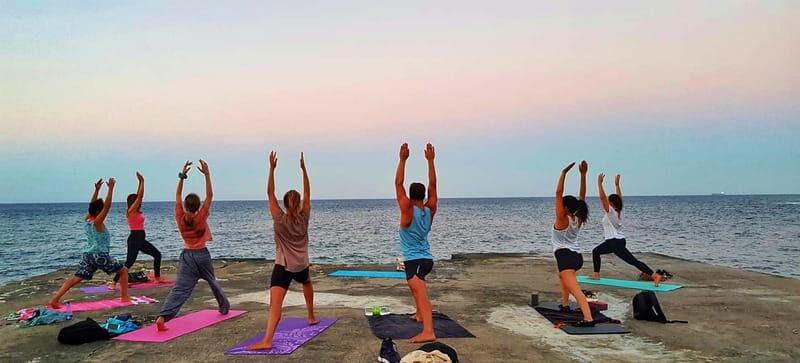 Sliema: Beach Yoga Class with Swimming - An Authentic Yoga Session by the Sea